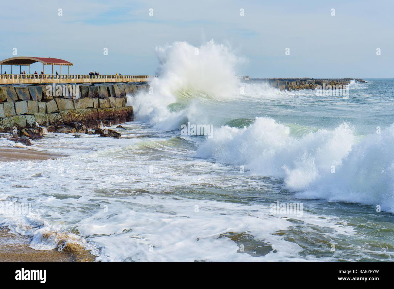 Dynamic waves crash against the rocky shore of Cabrillo Beach Pier ...