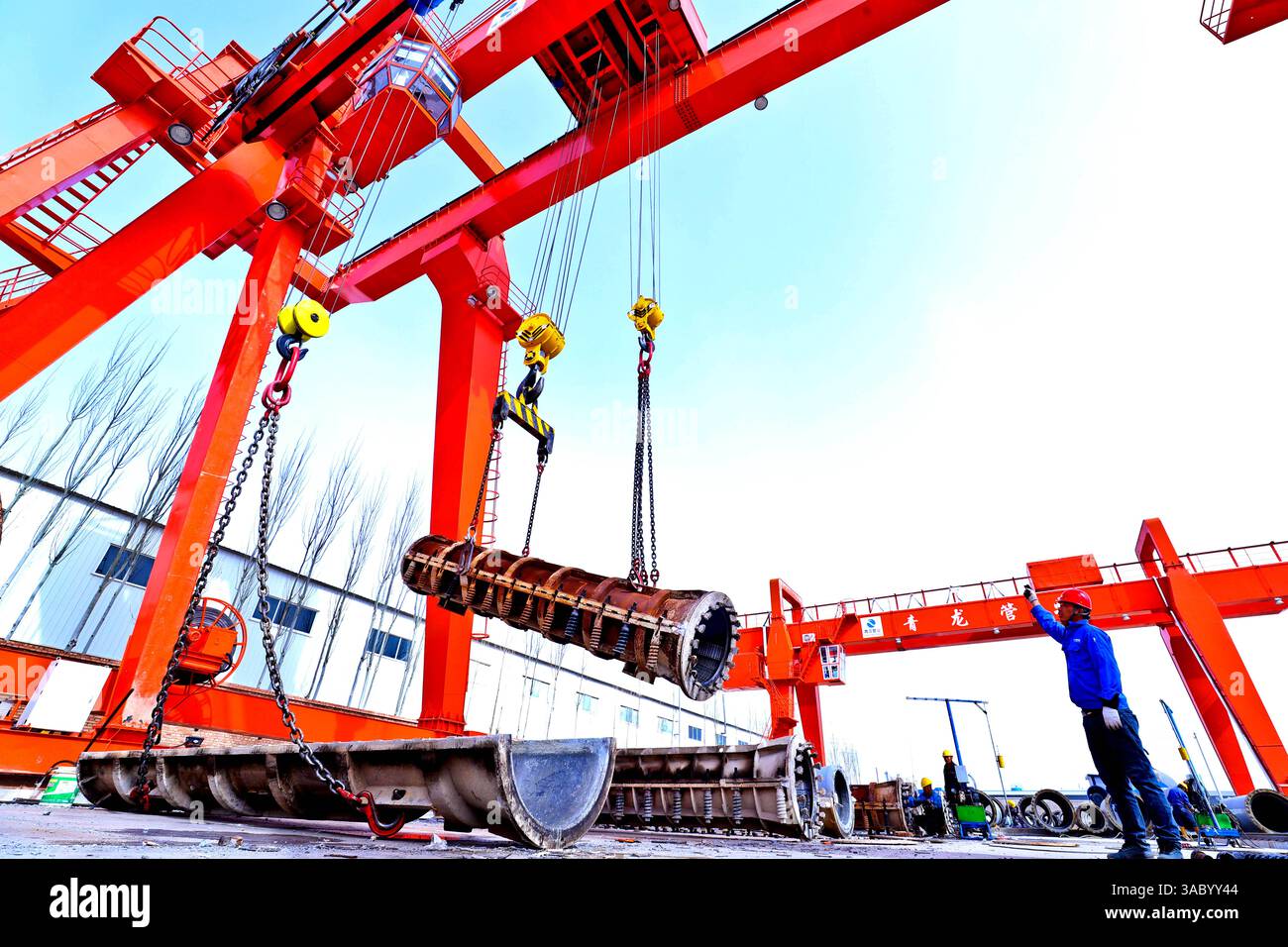 ZHANGYE, CHINA - APRIL 2, 2025 - Workers lift PCP pipe molds on the PCP ...
