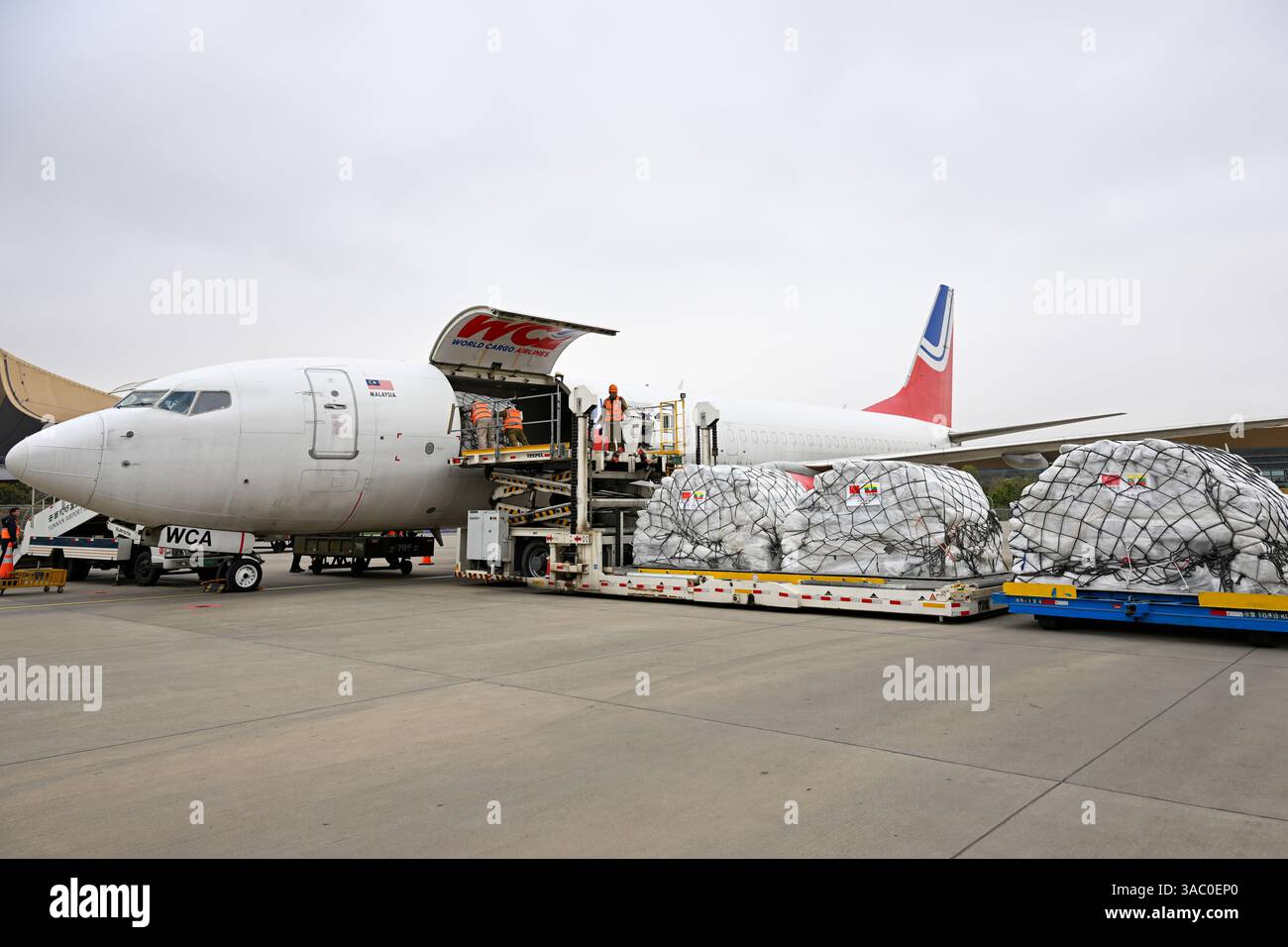 Kunming,China.2nd April 2025. Staff members load relief materials onto ...