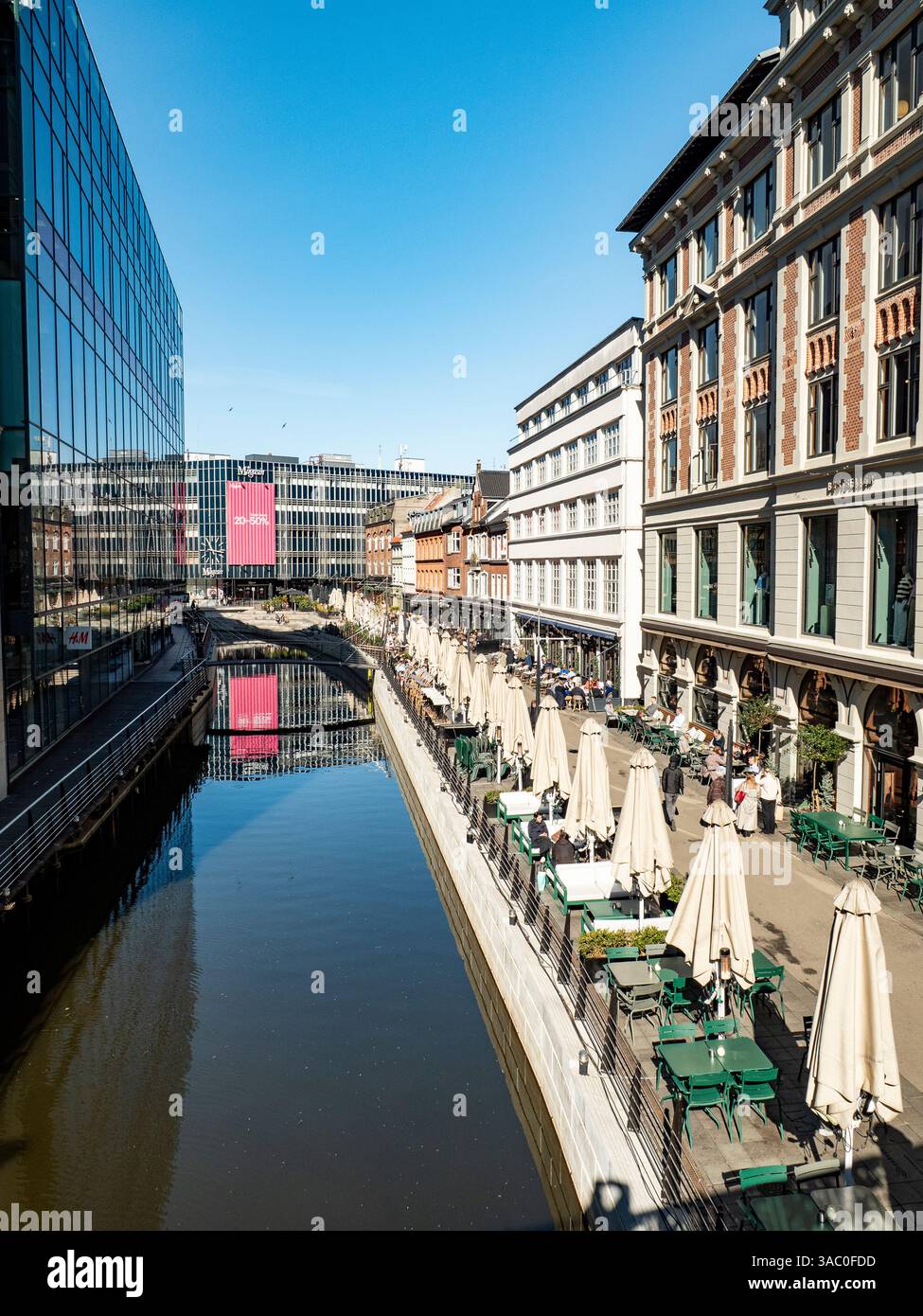 View of Aarhus with cafes and a comercial building with a big on sale ...