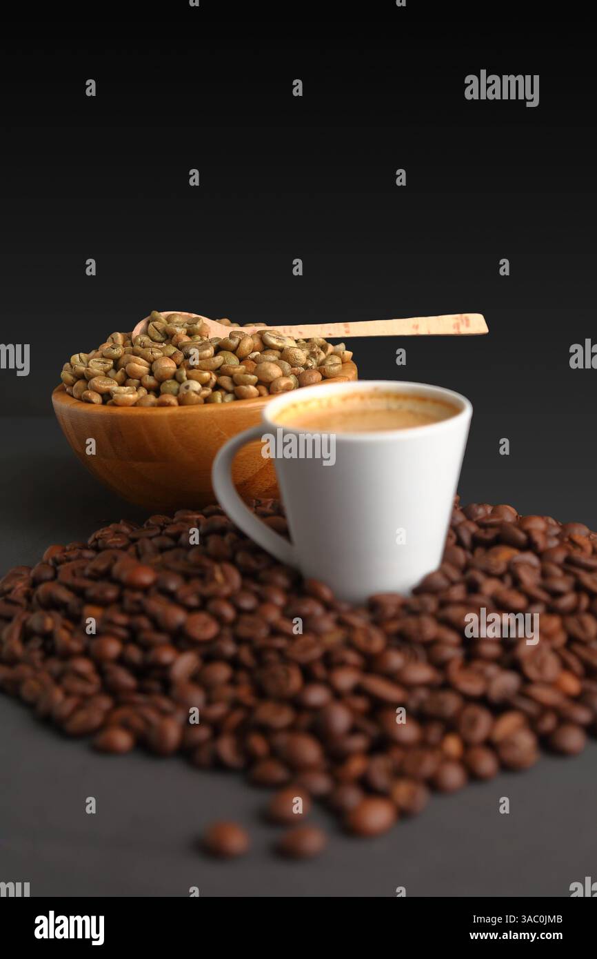 Espresso surrounded by roasted and green beans, emphasizing coffee ...