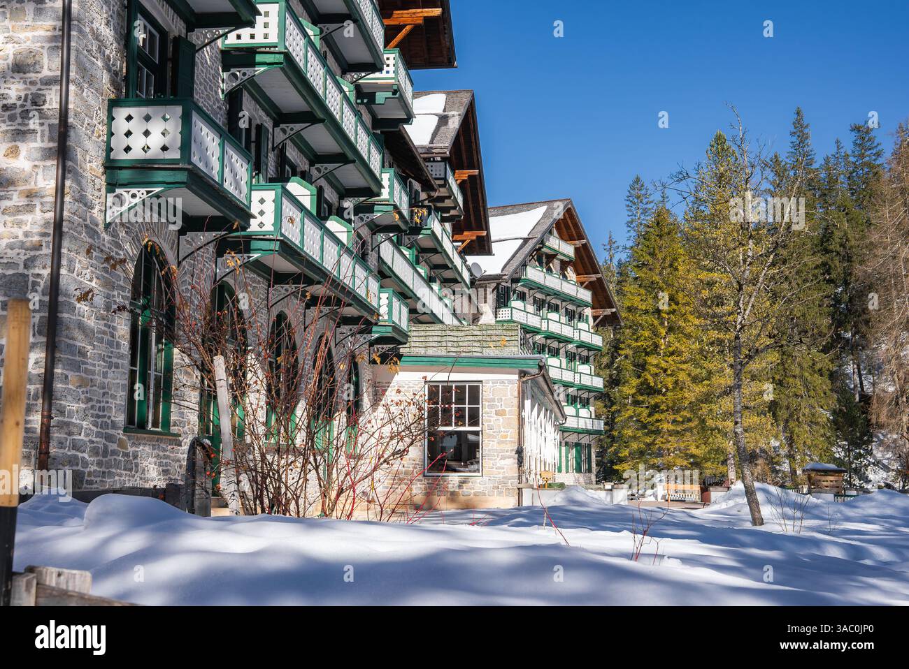 Alpine Style Building with Snow and Evergreen Trees in Italy Stock ...