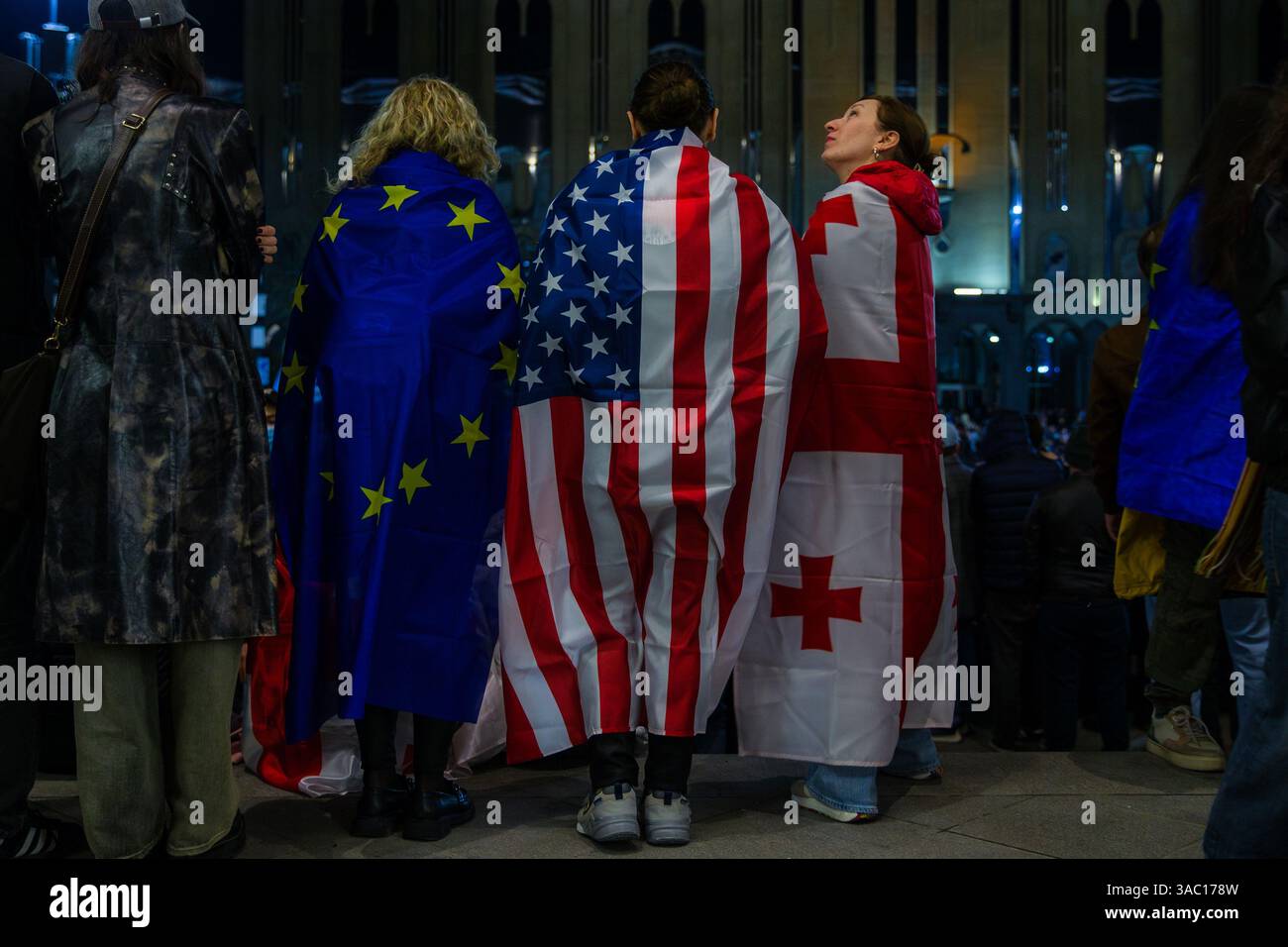 Pro-European protesters at the Parliament building draped in EU, U.S ...