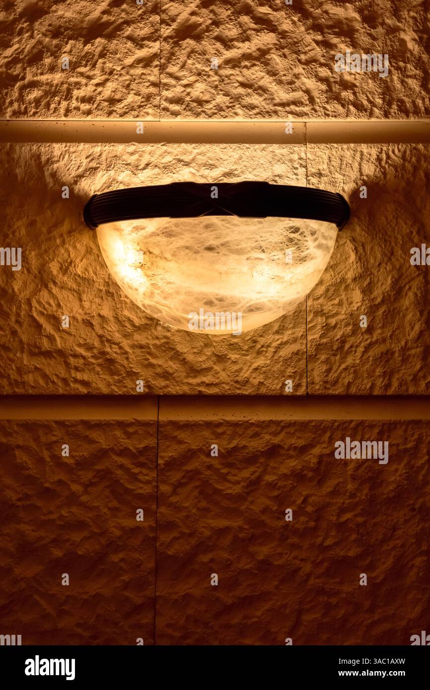 Facade lighting with semi-spherical fixture mounted on natural stone ...