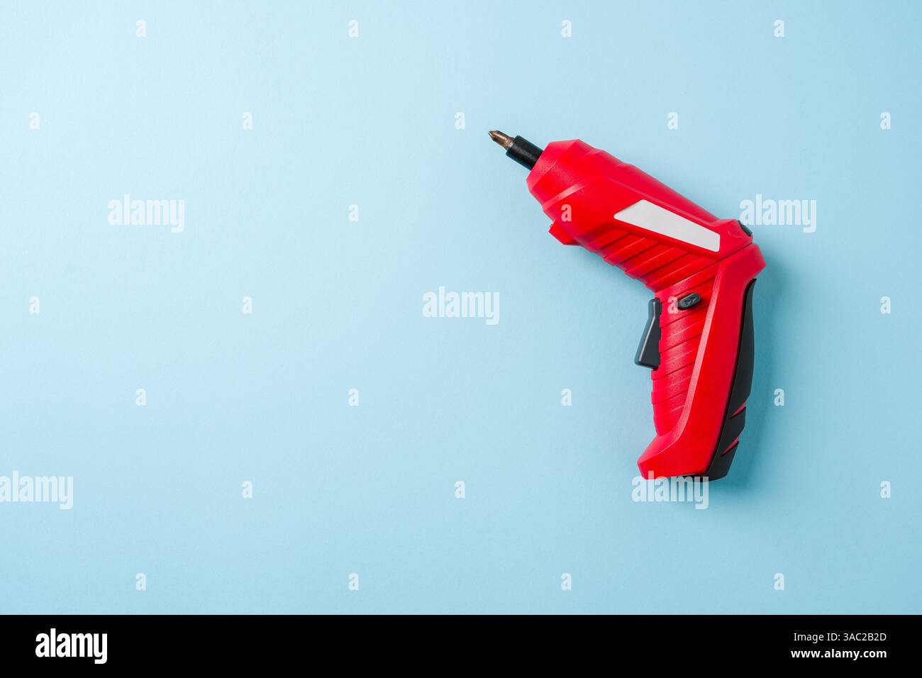 Top view of red cordless mini screwdriver on blue background Stock ...