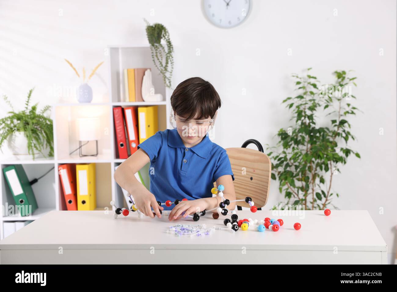Boy making DNA structure model at desk indoors Stock Photo - Alamy