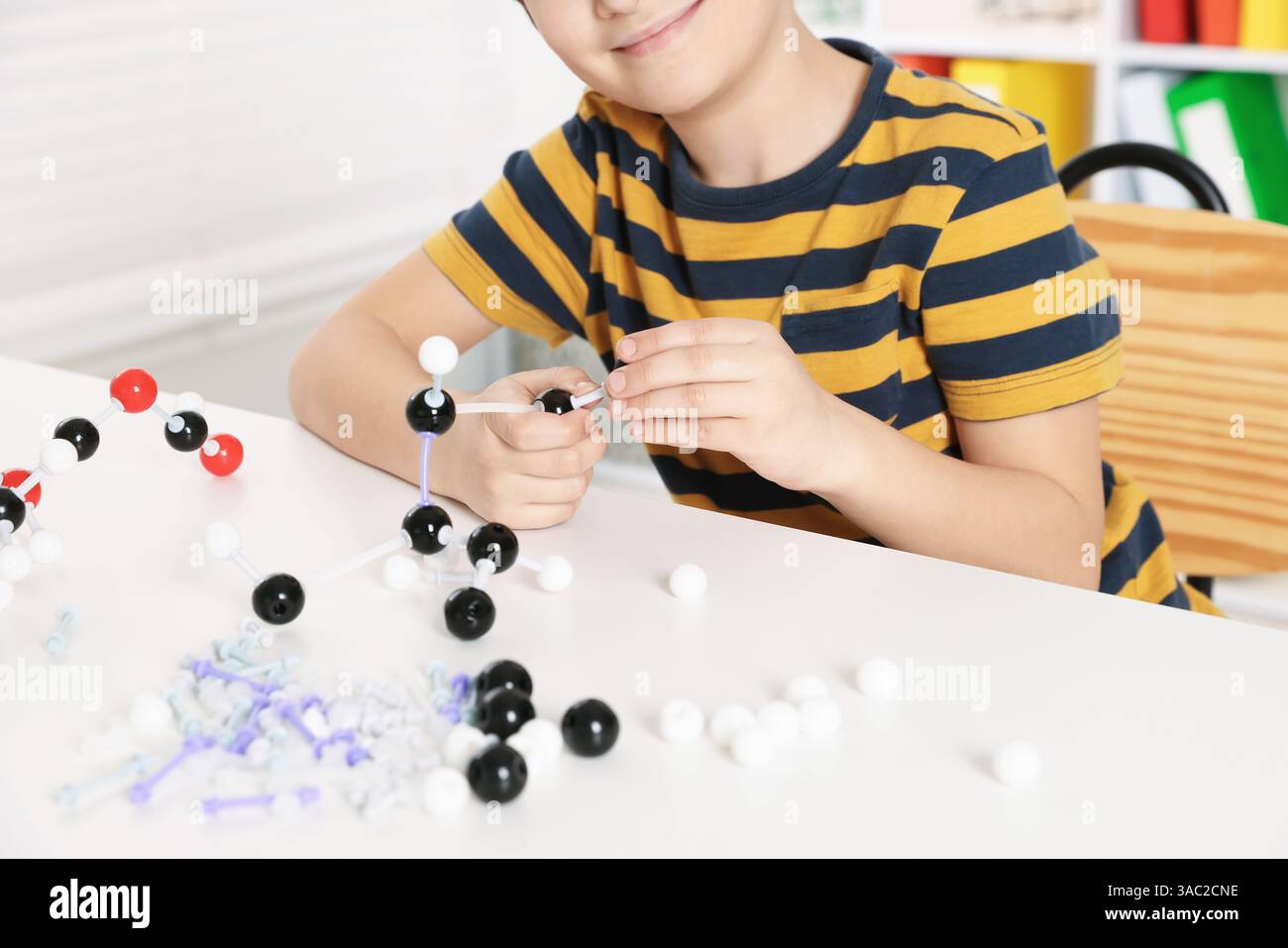 Boy making DNA structure model at desk indoors, closeup Stock Photo - Alamy
