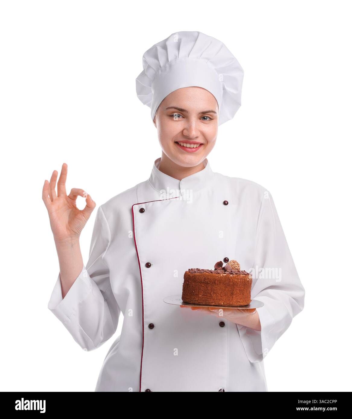 Happy confectioner in uniform holding delicious chocolate cake and ...