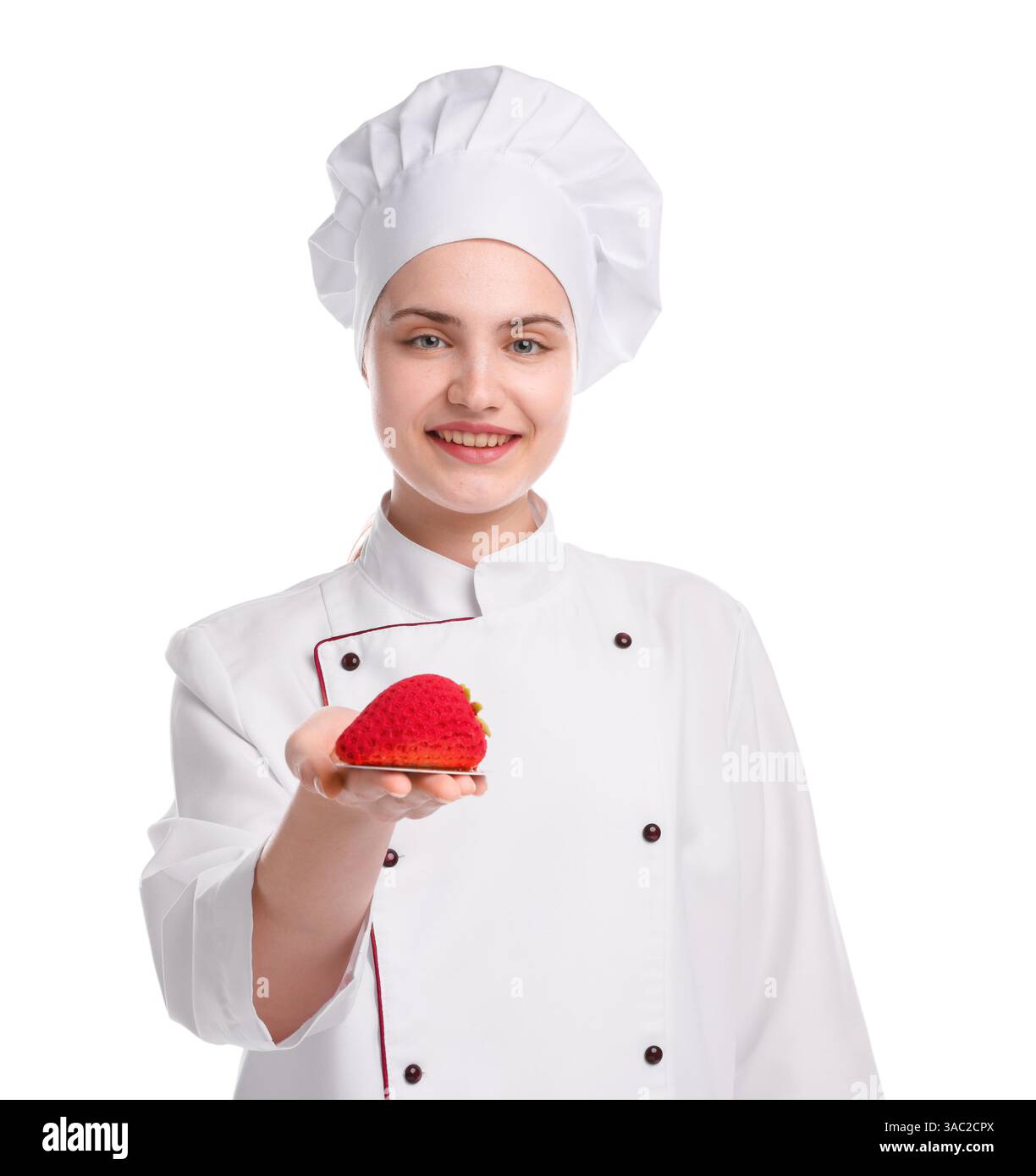 Happy confectioner in uniform holding delicious strawberry shaped ...