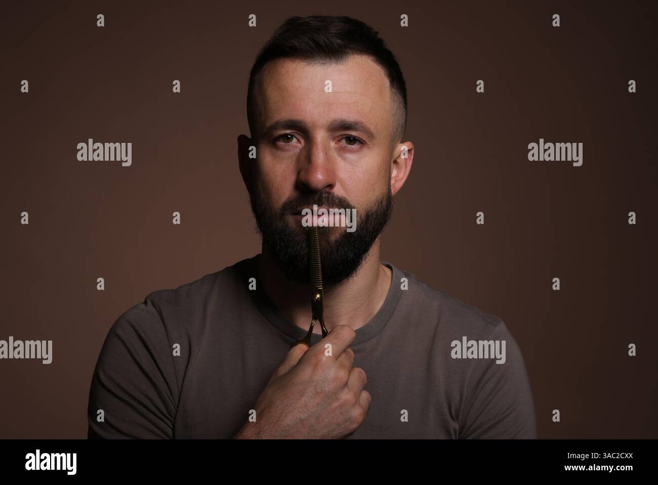 Bearded barber holding haircut hi-res stock photography and images - Alamy