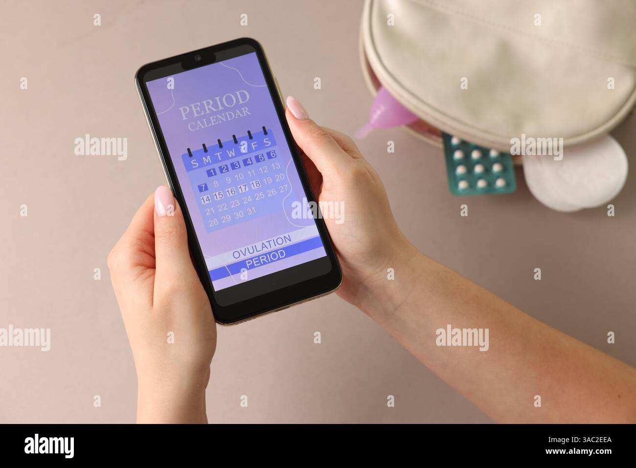 Menstruation. Woman holding smartphone with period calendar application ...