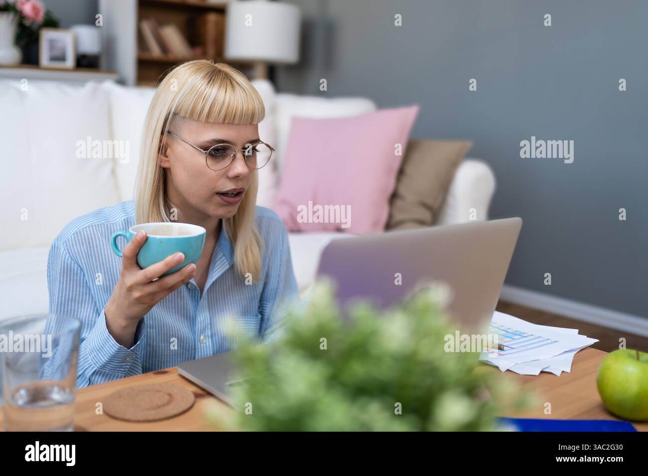 Young educated teacher woman teaching school kids online on laptop computer and video call. E ...
