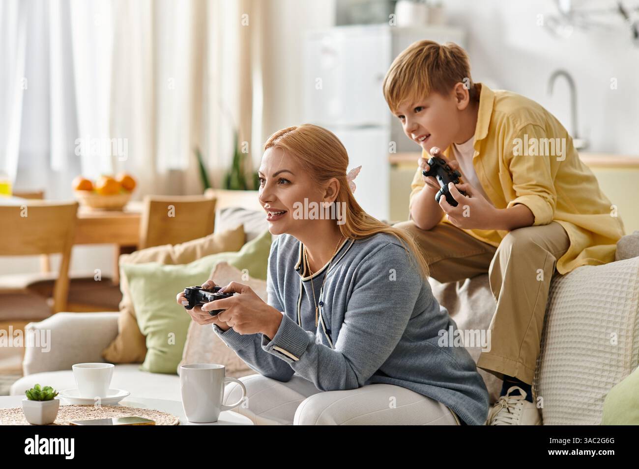 Mother and son engage in fun gaming together at home, sharing laughter ...