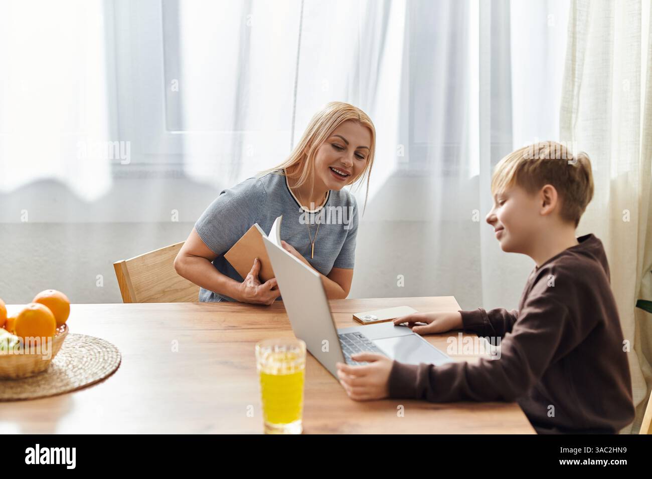 A Mother And Son Engage In An Interactive Learning Session At Their 5873