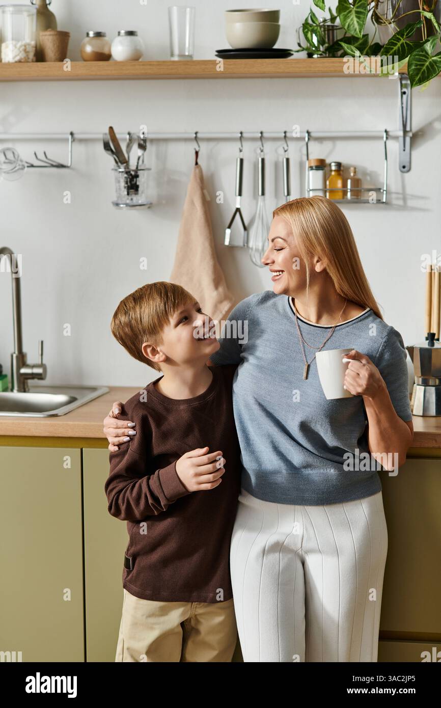 Woman and boy enjoy a loving interaction in a stylish kitchen ...