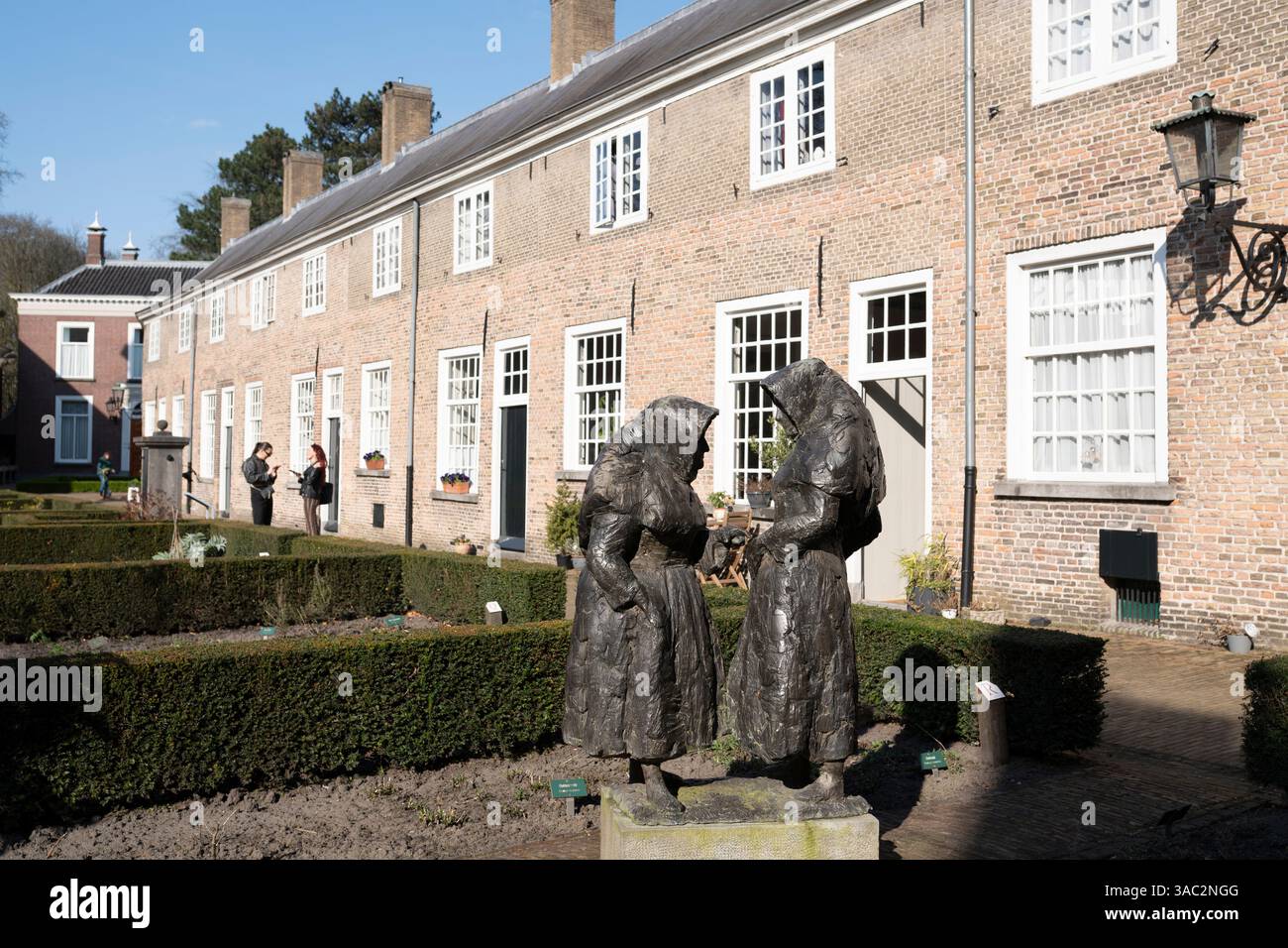 Statue of two beguines at the courtyard of the beguinage of Breda in ...