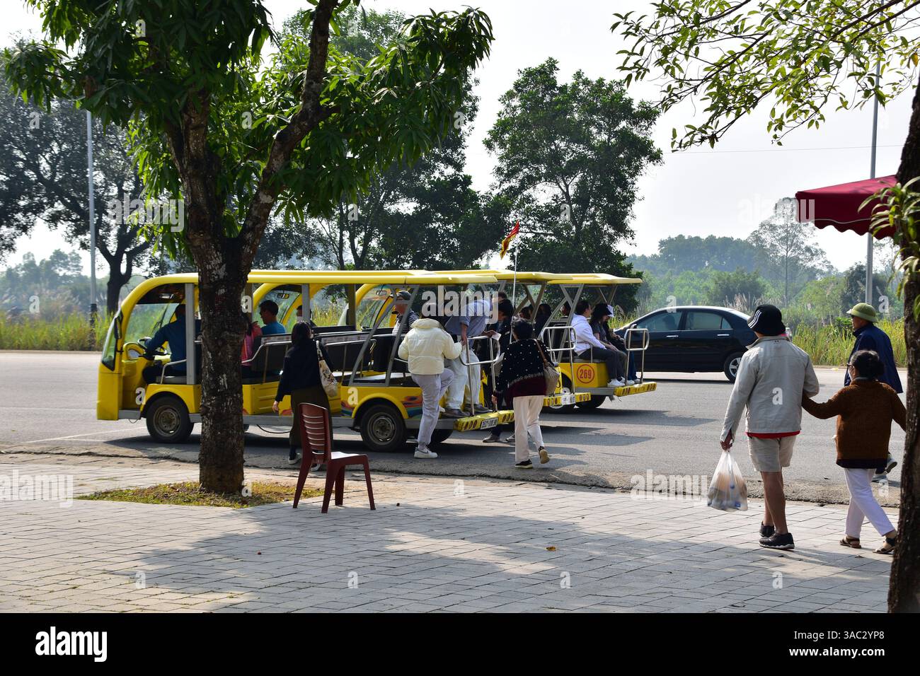 Yellow electric shuttle bus transporting people from the visitor center ...