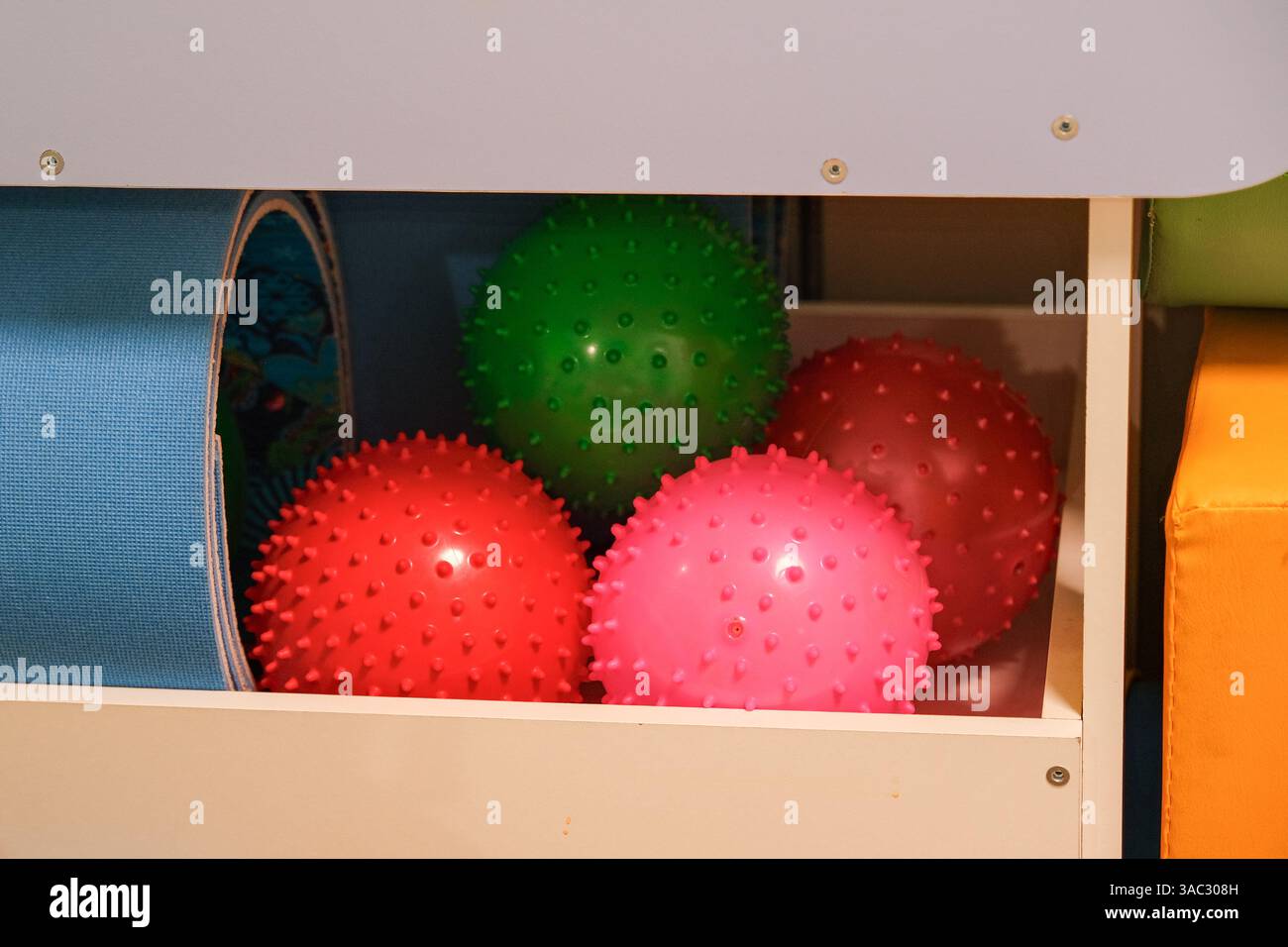 A white box with red and green balls inside. The balls are different ...