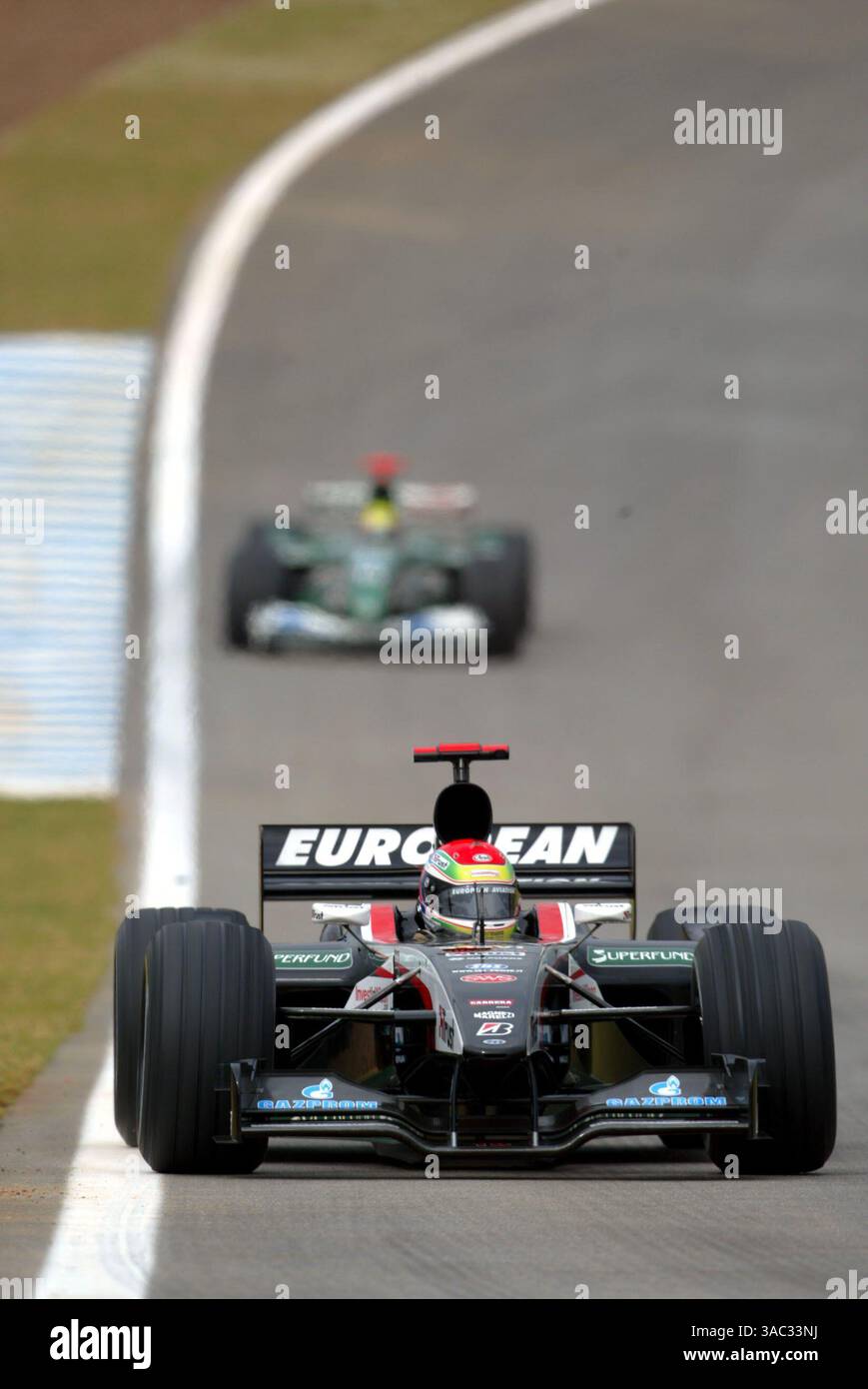 Justin Wilson (GBR) Minardi Cosworth PS03 leads Mark Webber (AUS ...
