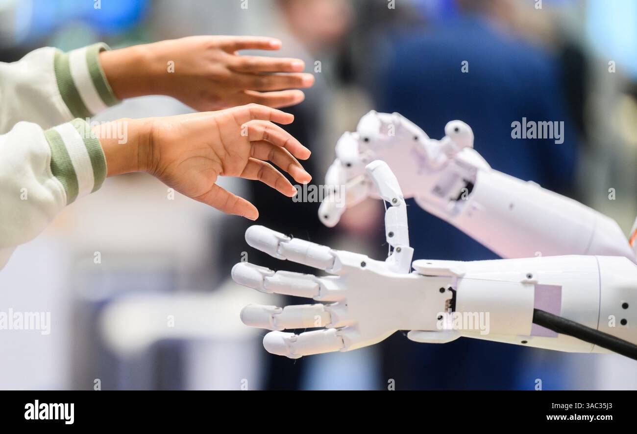 Hanover, Germany. 03rd Apr, 2025. A child communicates with a robot ...