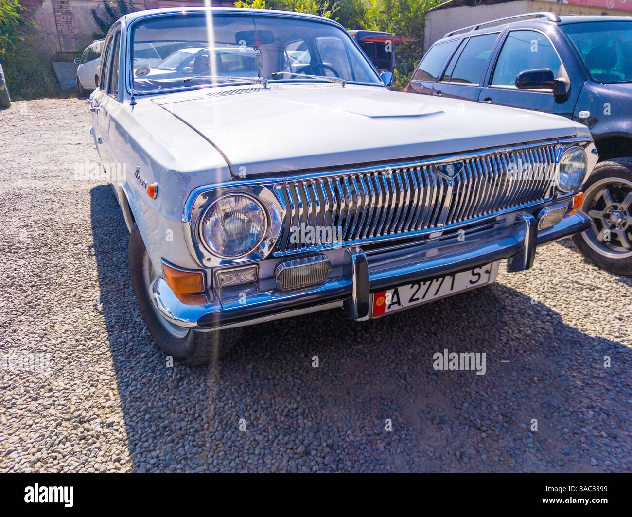 White Vintage Volga GAZ-24 Car Parked on Gravel Lot in Kyrgyzstan Stock ...