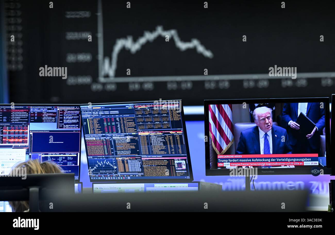 03 April 2025, Hesse, Frankfurt/Main: Behind a television monitor ...