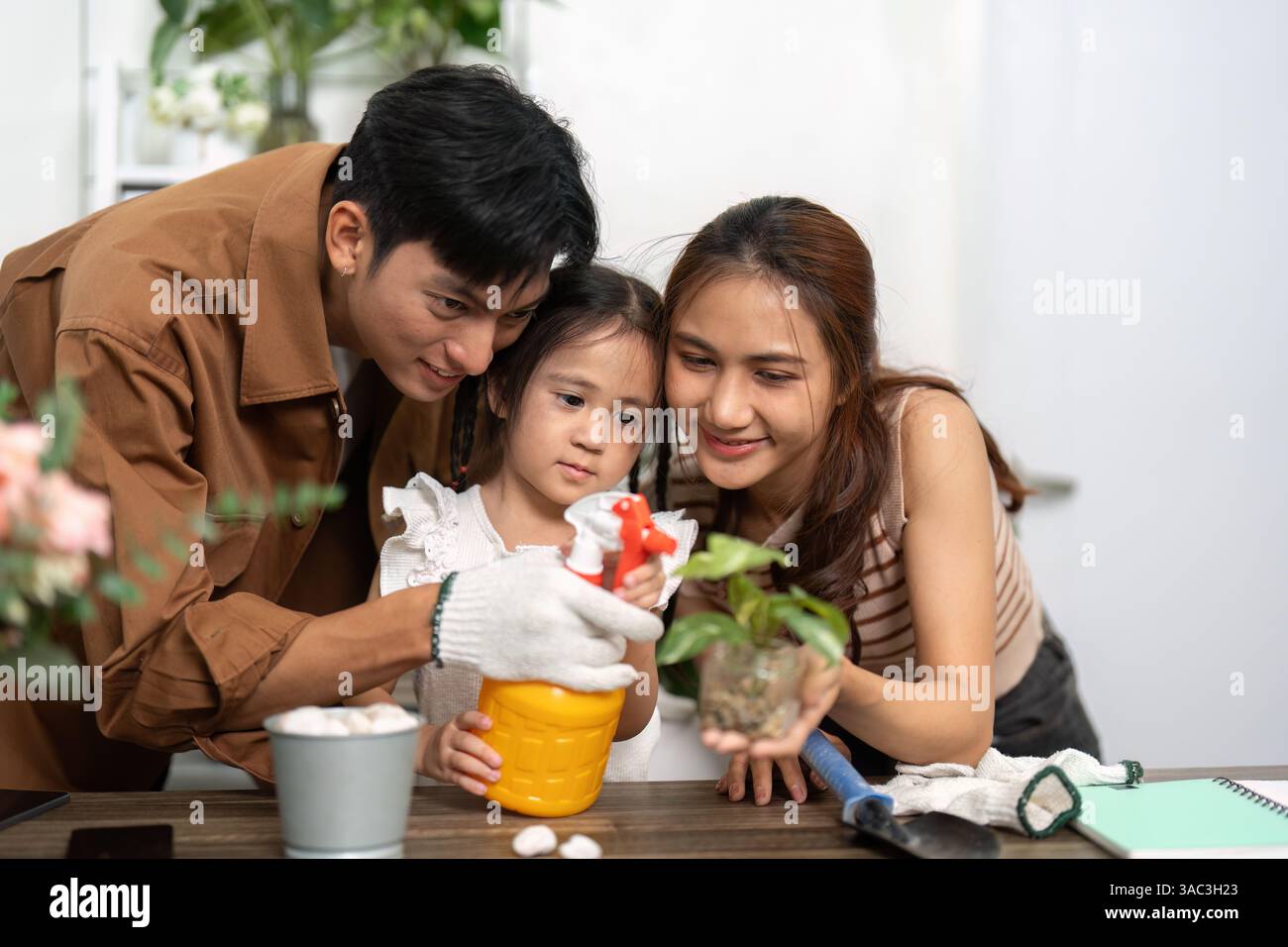 Family Bonding and Sustainability. A family engages in a planting ...