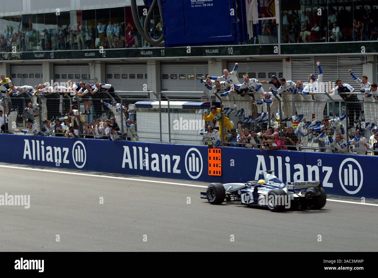 The Williams team celebrates from the pit wall as Ralf Schumacher (GER ...