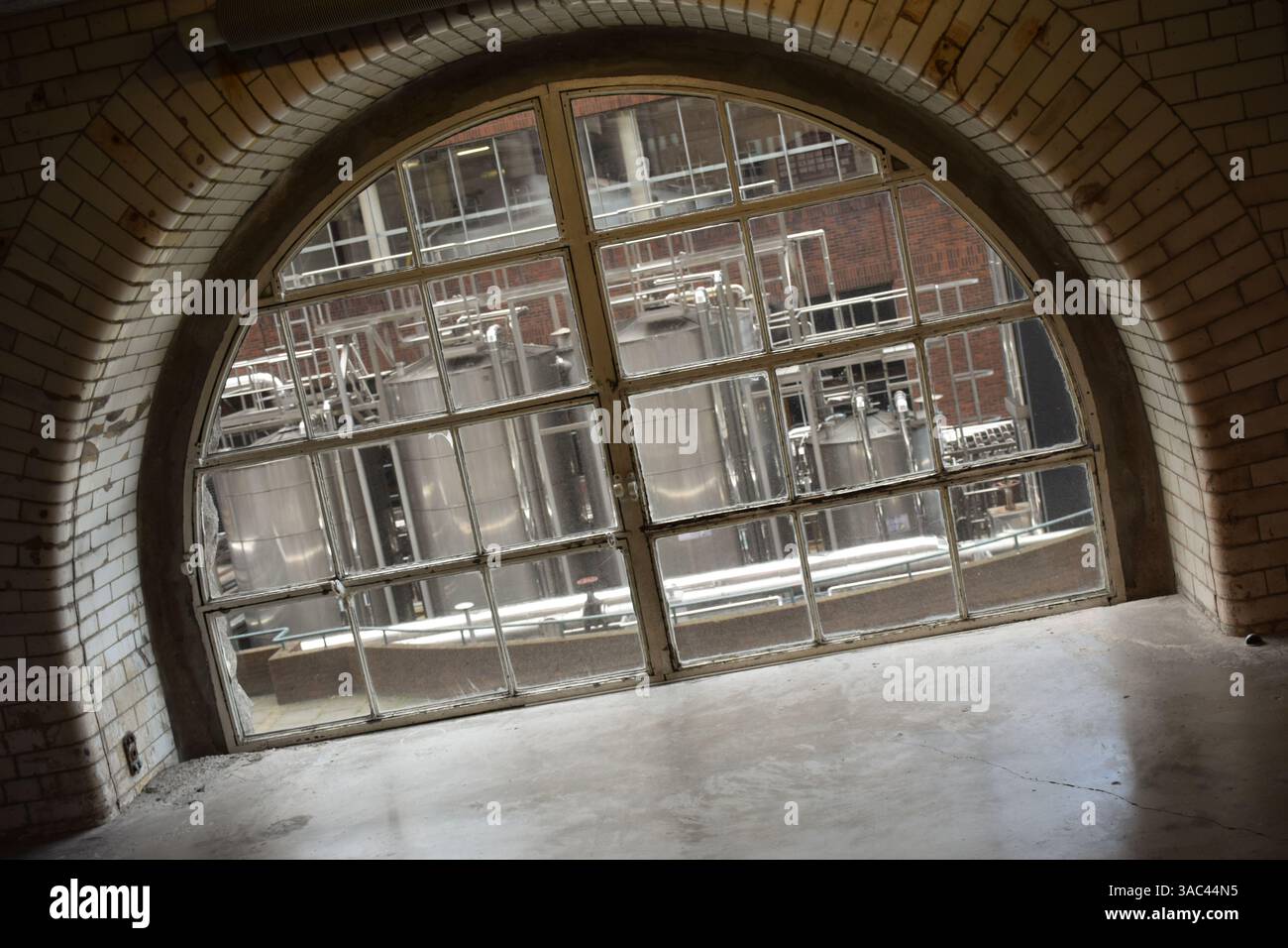 Industrial Tank Farm Through Arched Window with white tiled frame Stock ...