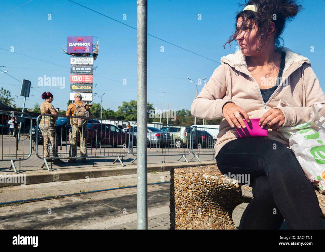 Kyiv, Ukraine - 1st April, 2025: A woman sits on a bench, quietly ...