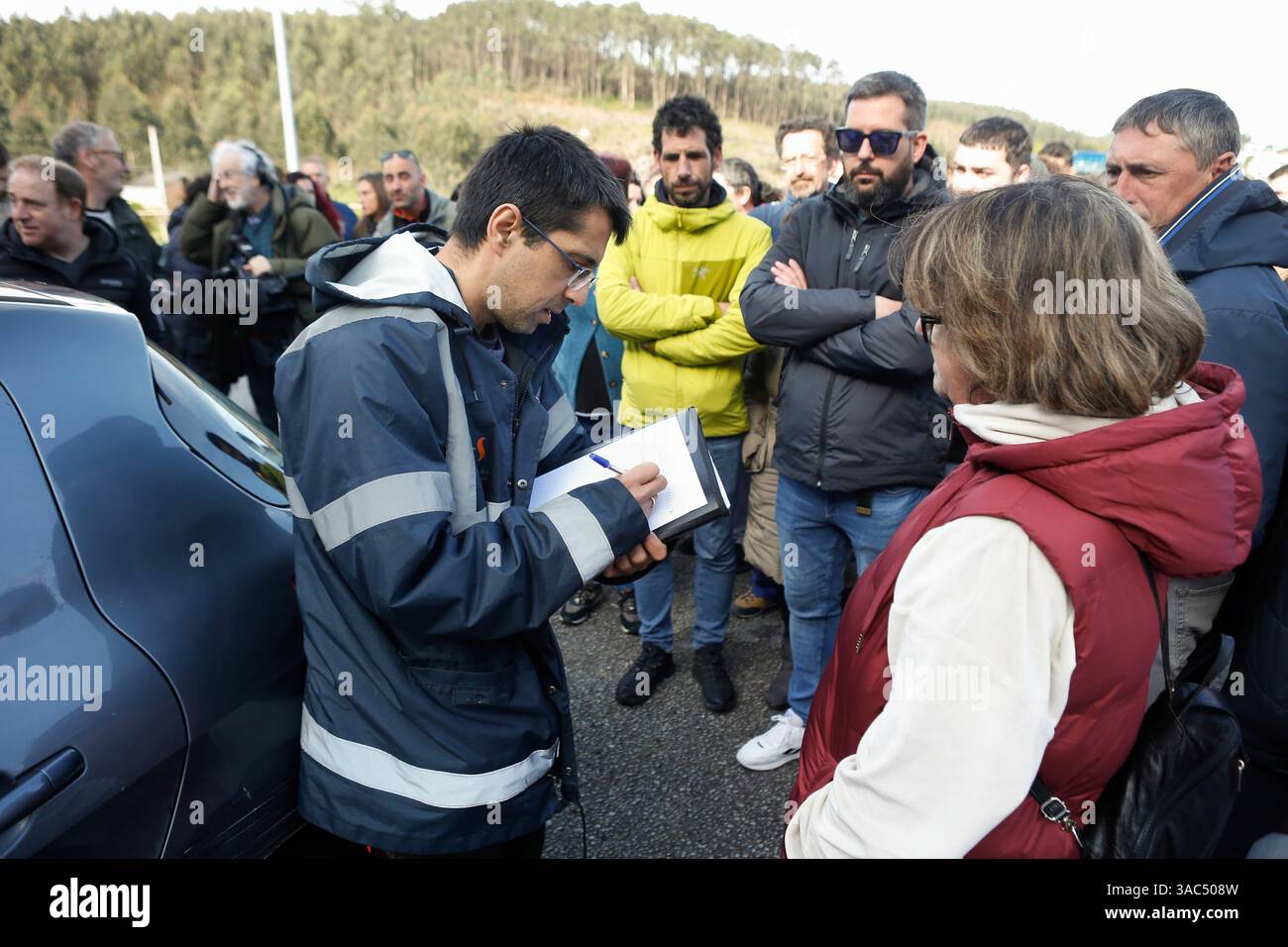 An inspector next to workers at the Sargadelos ceramics factory, who ...