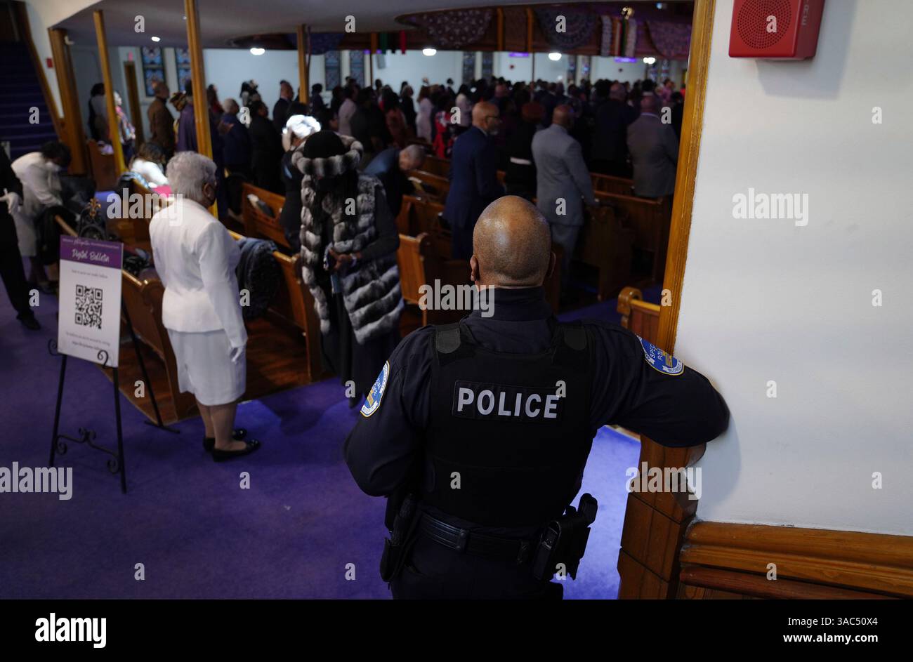 A security agent monitors the service at Metropolitan African Methodist ...