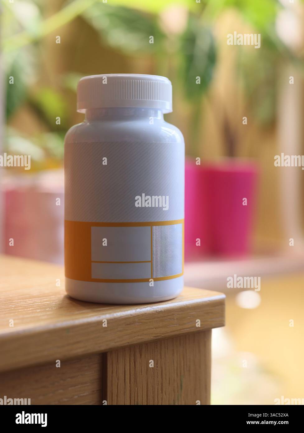 A Minimalist White Supplement Bottle Featuring a Distinctive Orange ...