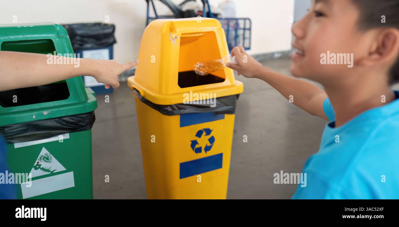 Recycling and Education. A child learning to recycle while actively ...