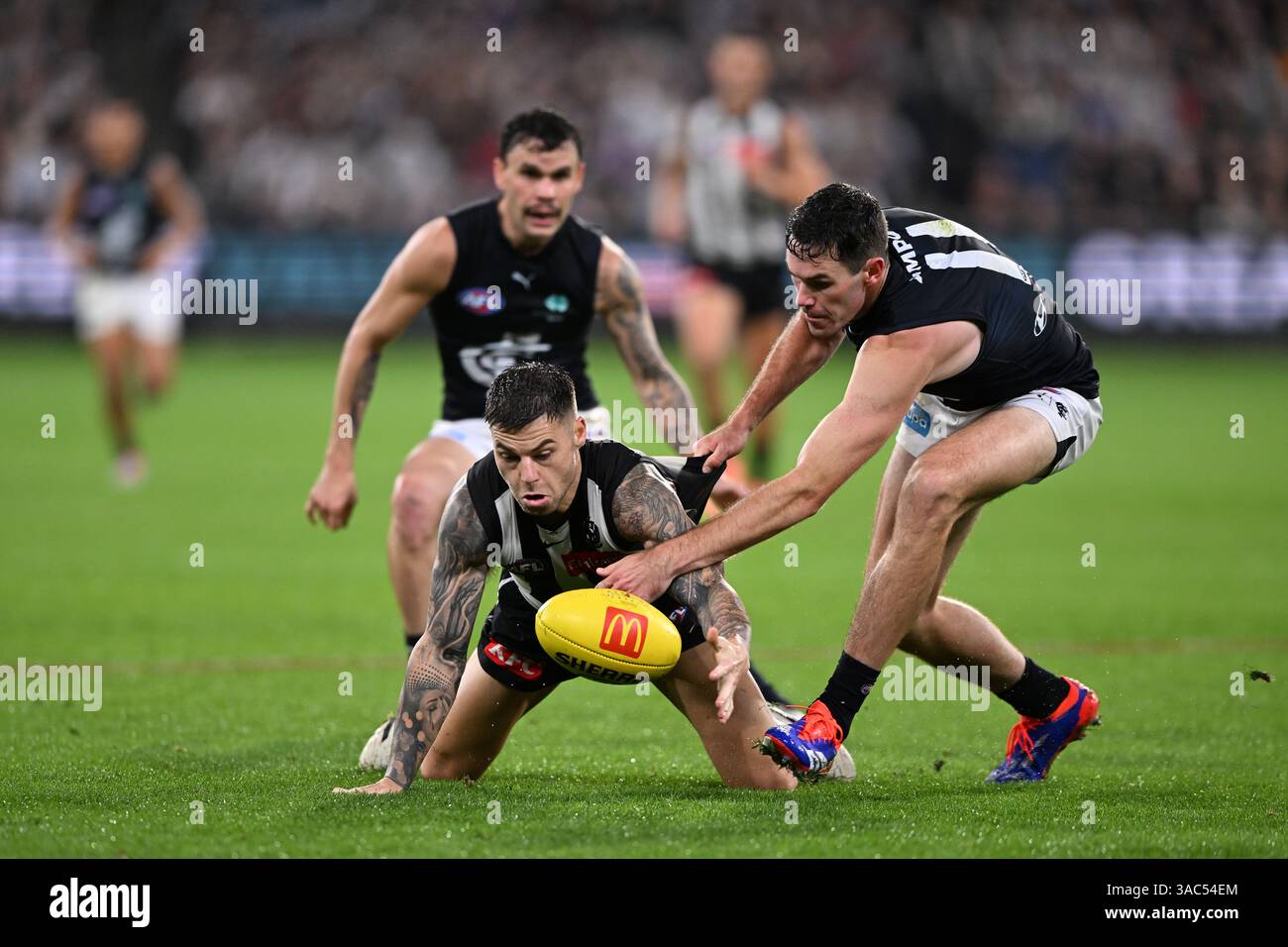 Jamie Elliott of Collingwood and Mitch McGovern of Carlton in action ...