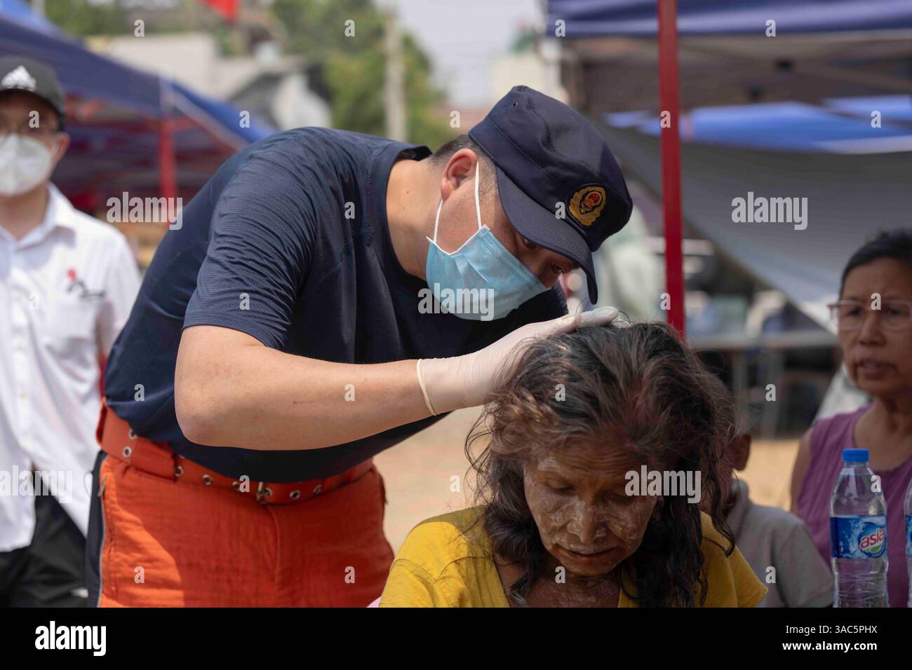Mandalay, Myanmar. 3rd Apr, 2025. A Chinese rescuer checks the ...