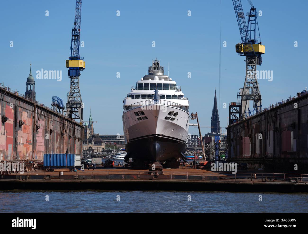 03 April 2025, Hamburg: Shipyard workers work on the megayacht "Rising ...