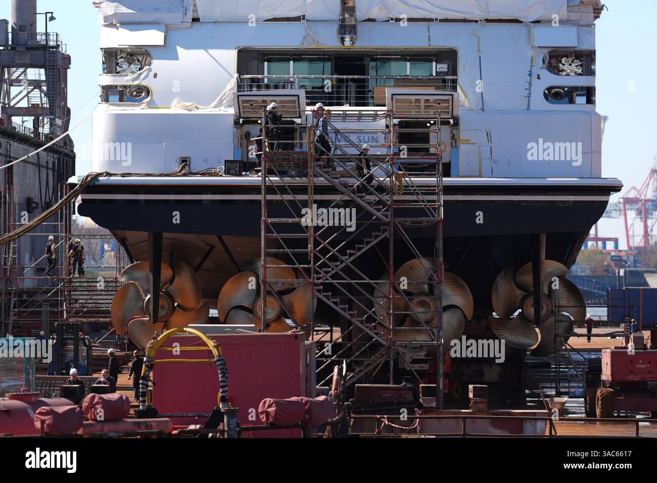 03 April 2025, Hamburg: Shipyard workers work on the megayacht "Rising ...