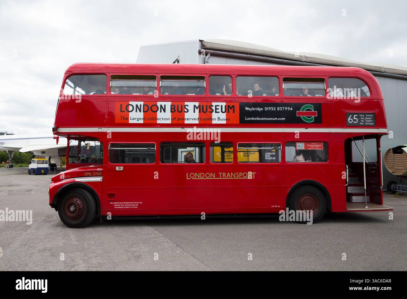 Number 65 routemaster red double decker bus and visitors / tourists at London Bus Museum ...
