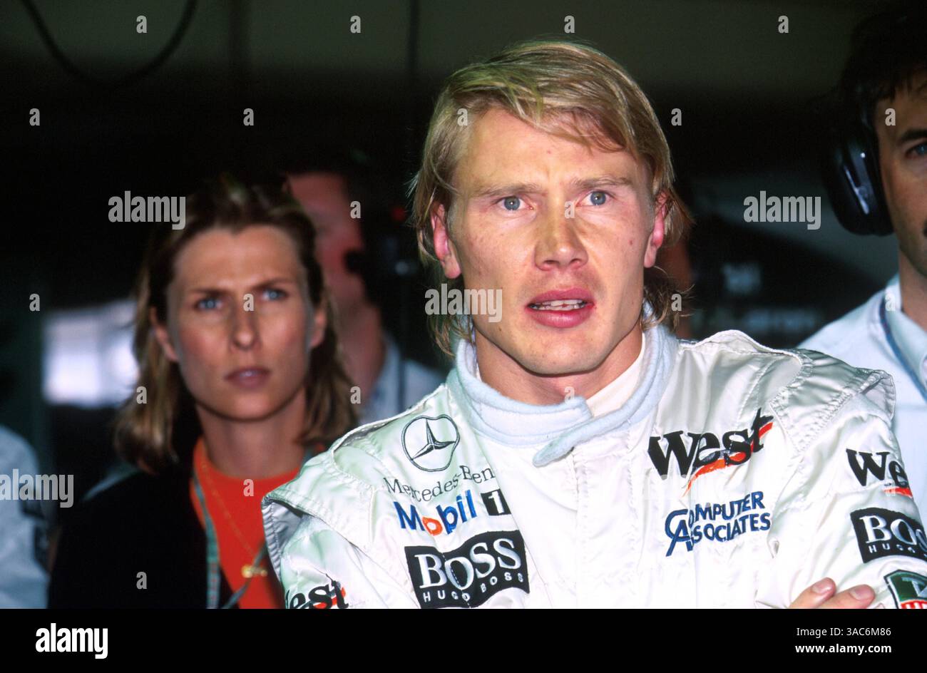 Mika Hakkinen (FIN) Mclaren watches progress out on track, with wife ...