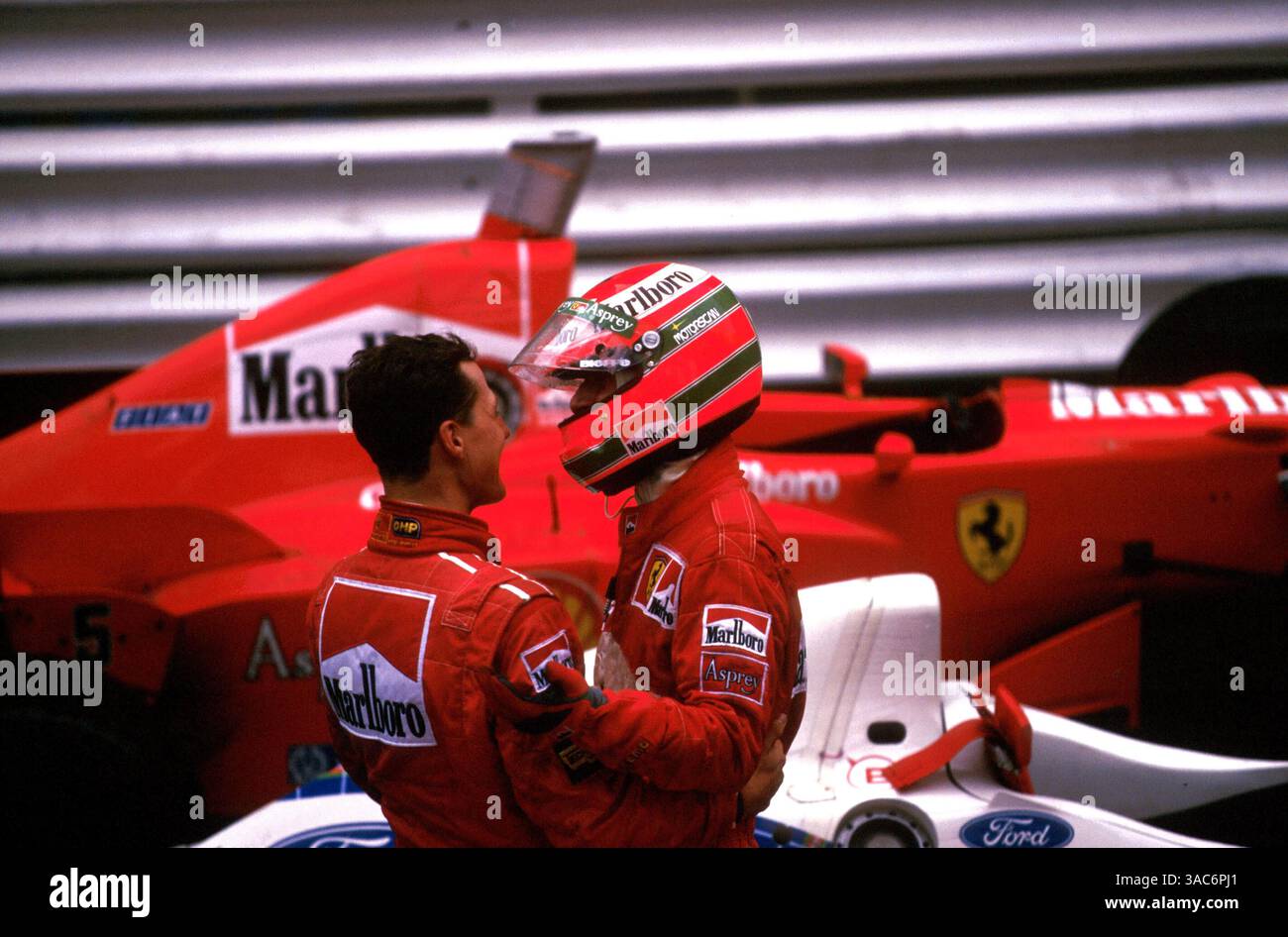 Eddie Irvine (GBR), Ferrari F310B 3rd place is congratulated by Michael ...