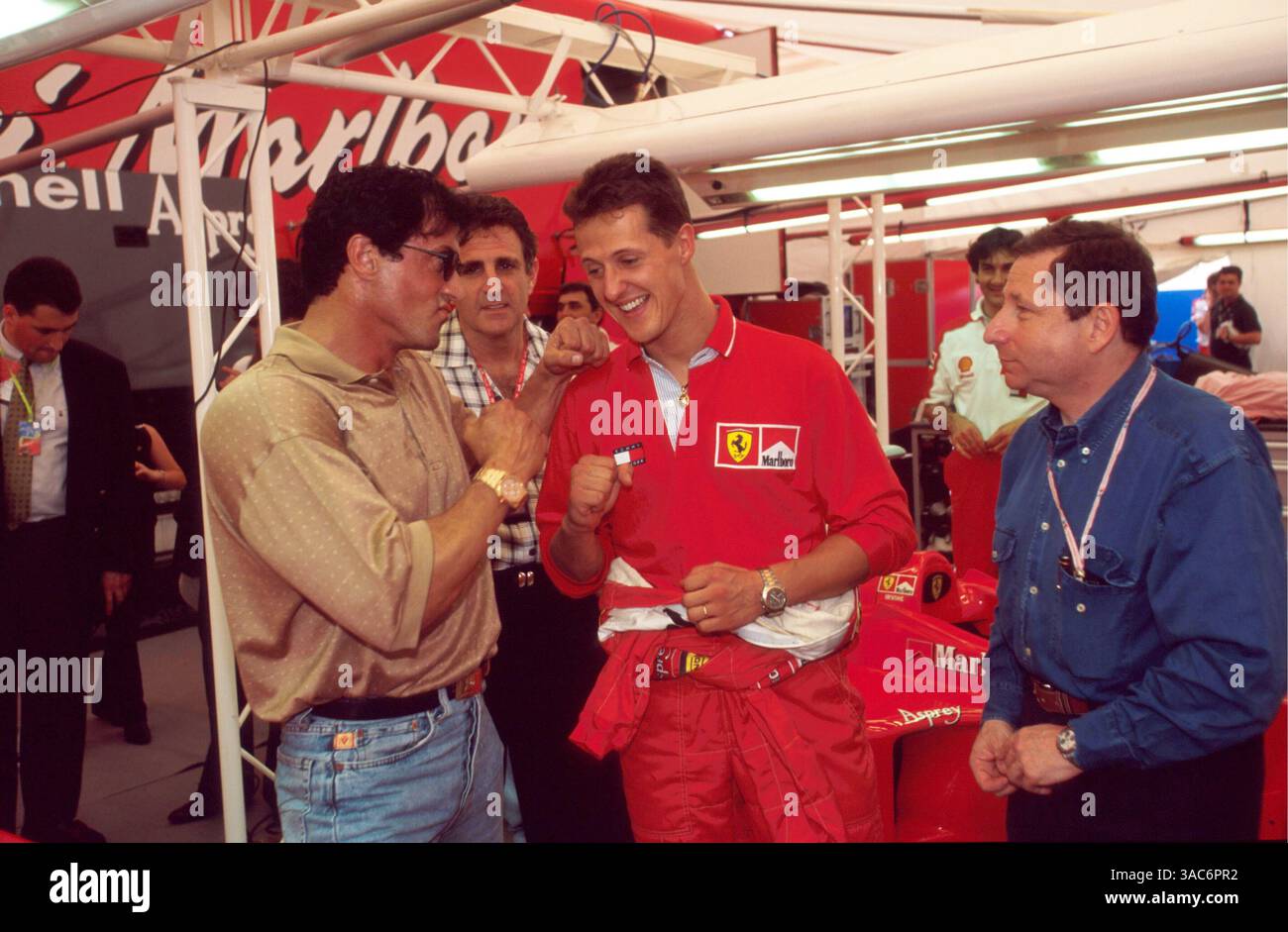 Actor Sylvester Stallone, left takes a pop at Michael Schumacher ...