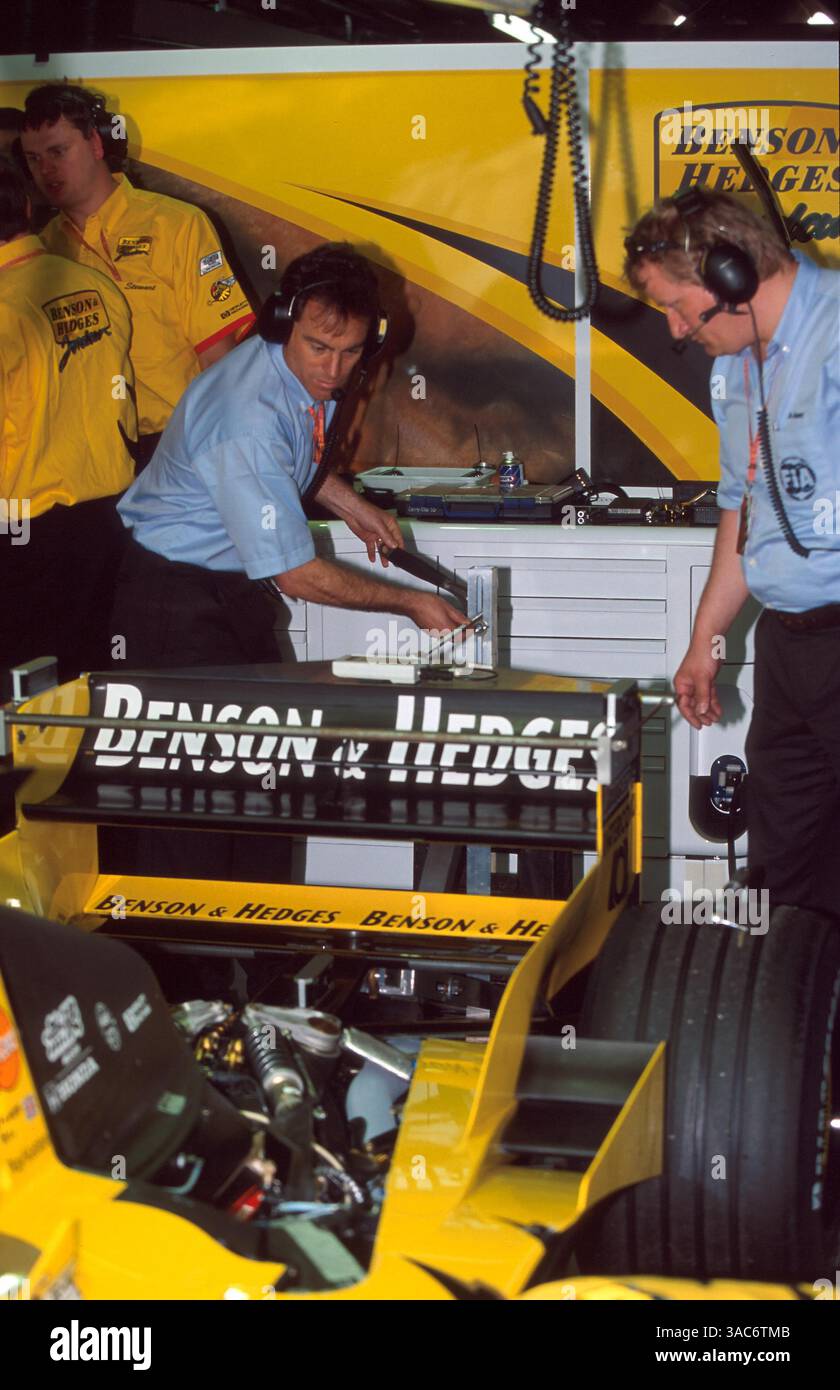 The FIA technical team make a check on the Jordan EJ10 rear wing ...