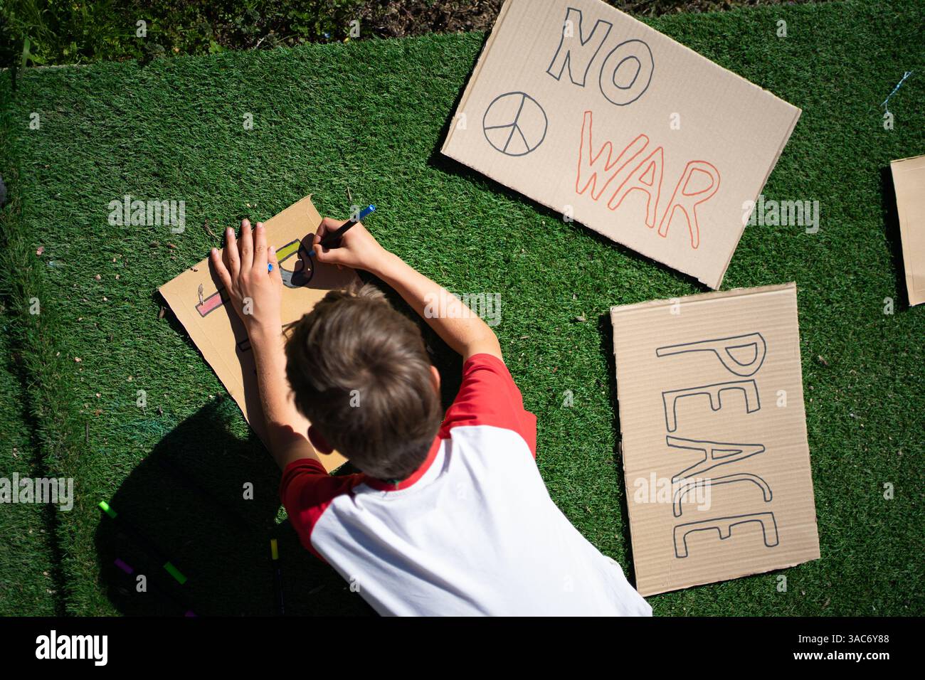 Boy drawing peace symbols preparing for a peace demonstration Stock ...