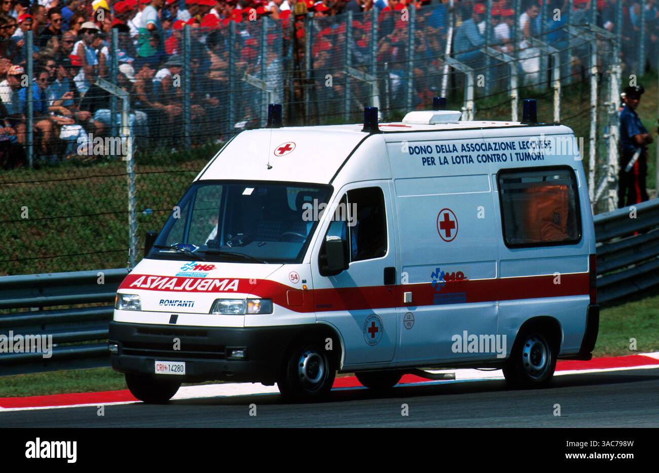 The ambulance carrying the marshal injured in the first lap accident ...