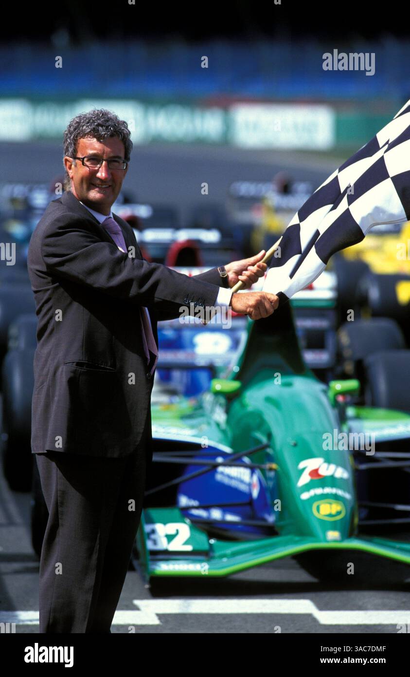 Eddie Jordan (IRL) Jordan team owner waves the Chequered flag over the ...