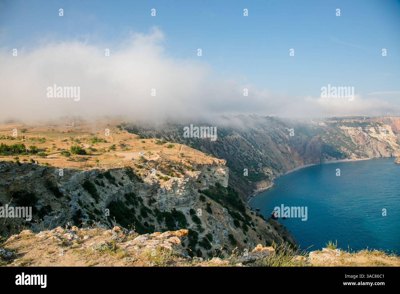 Light fog hugs the ridge, and the serene water stretches to the horizon ...