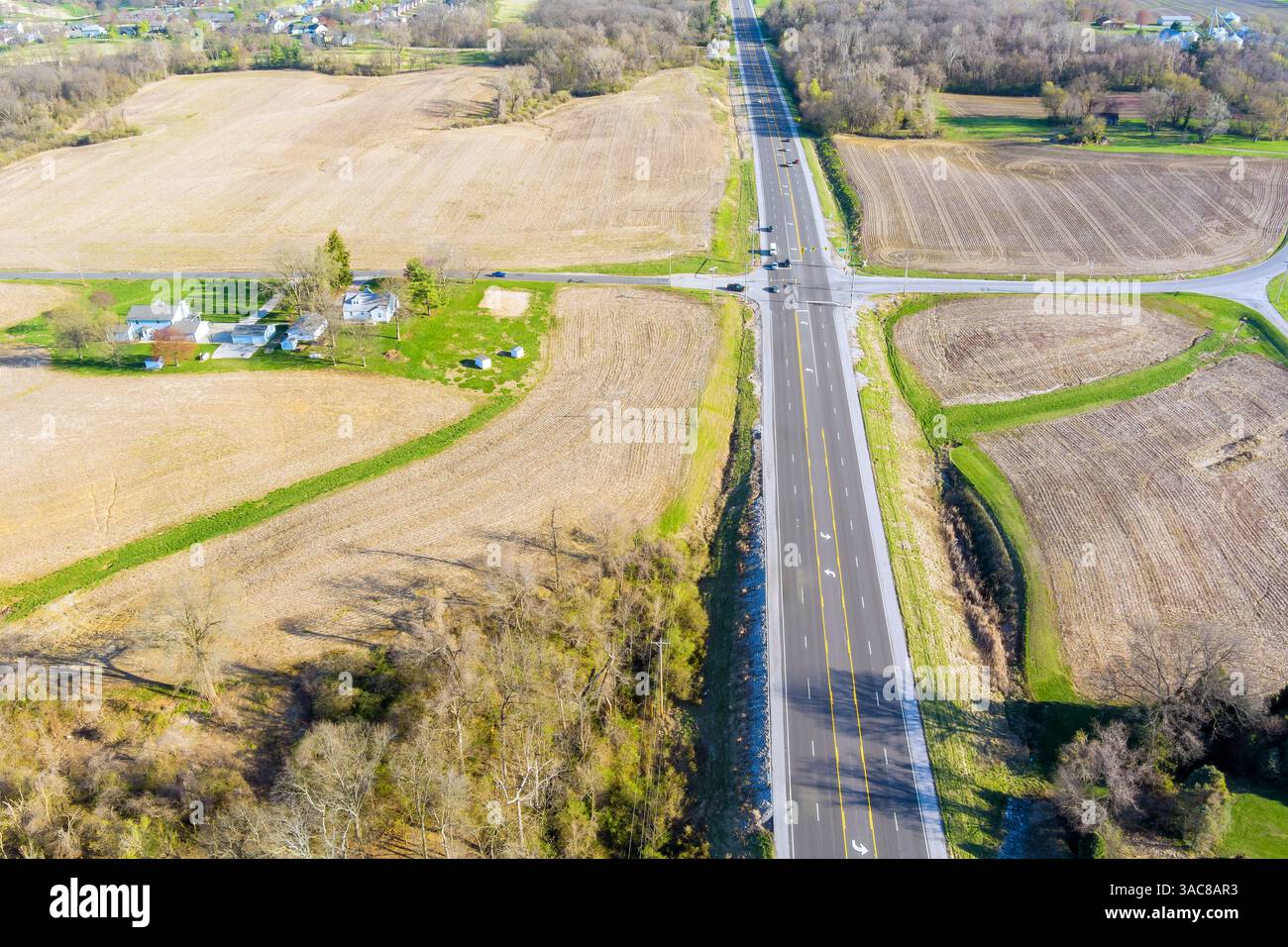 Rural intersection amidst vast farmland showcases nature tranquility in ...