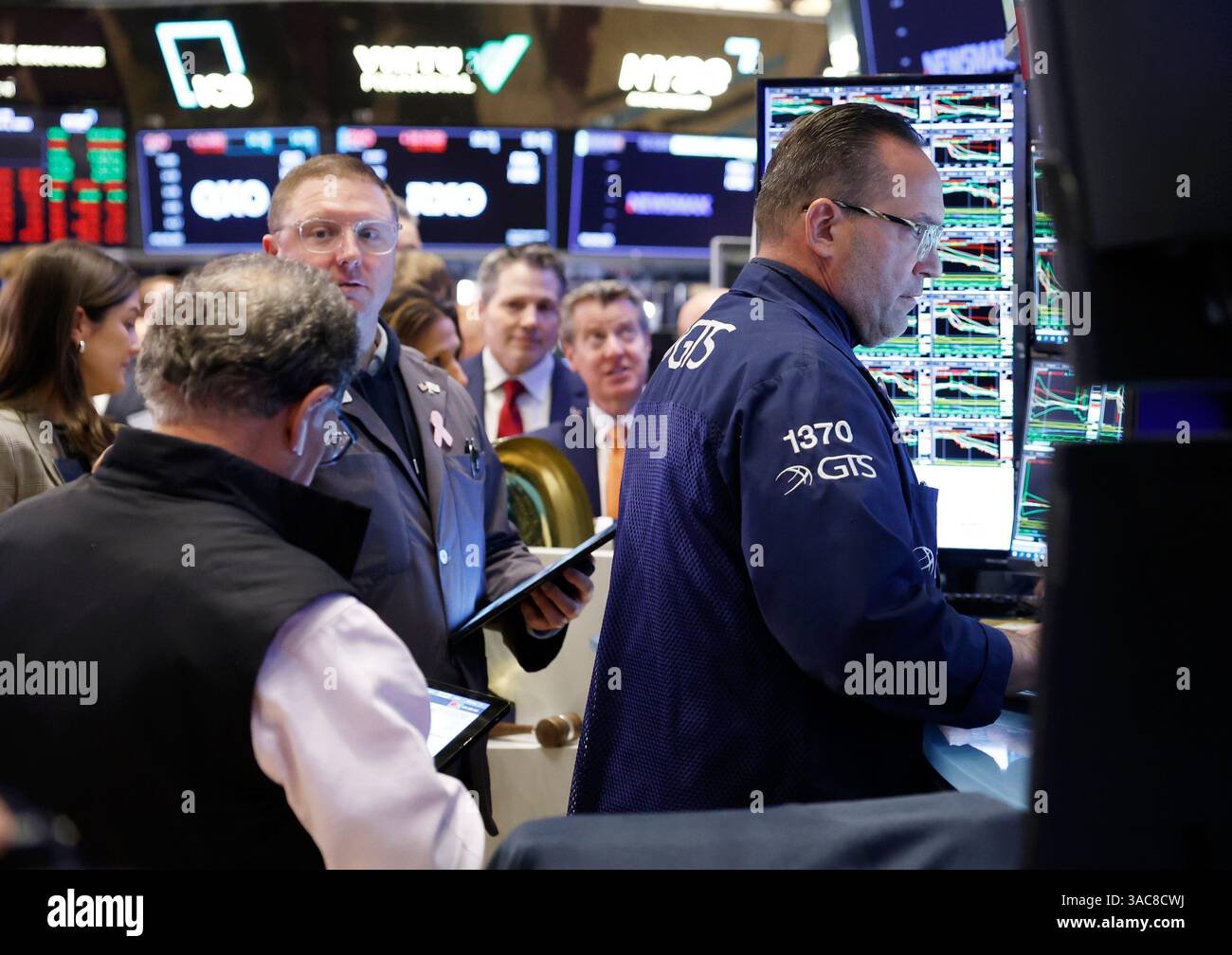 New York, United States. 03rd Apr, 2025. Traders work on the floor of ...