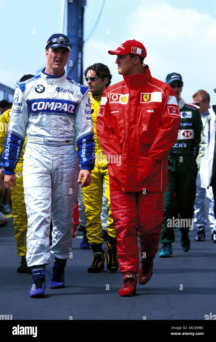 L-R) Ralf Schumacher (GER) chats to his brother Michael Schumacher (GER ...